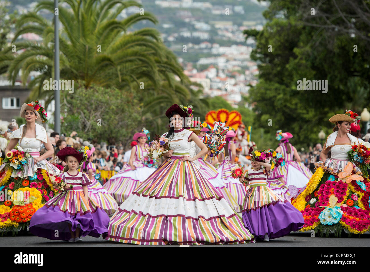 women dressed in colorful clothes at the Festa da Flor or Spring Flower ...