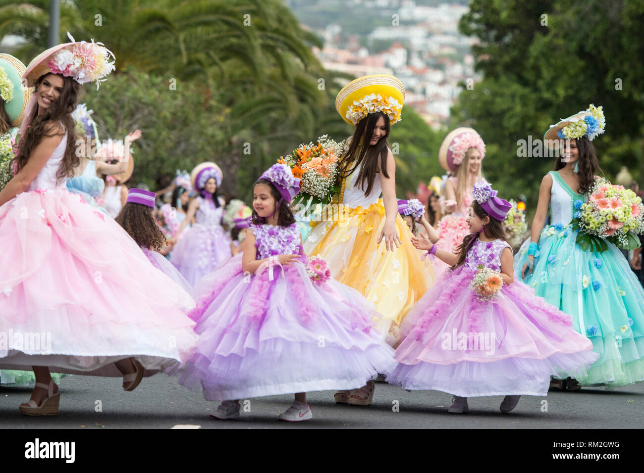 women dressed in colorful clothes at the Festa da Flor or Spring Flower ...