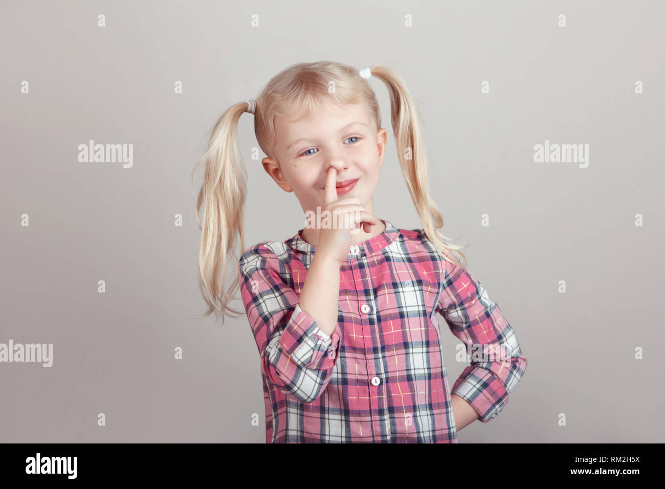 Closeup portrait of funny blonde Caucasian preschool girl picking nose ...
