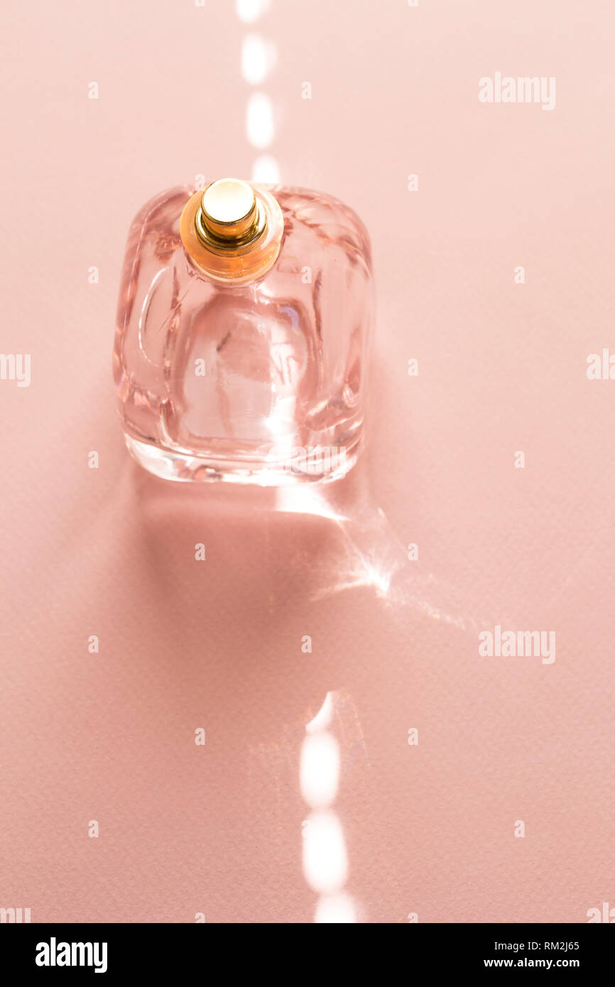 Perfume bottle with a ray of light Stock Photo - Alamy