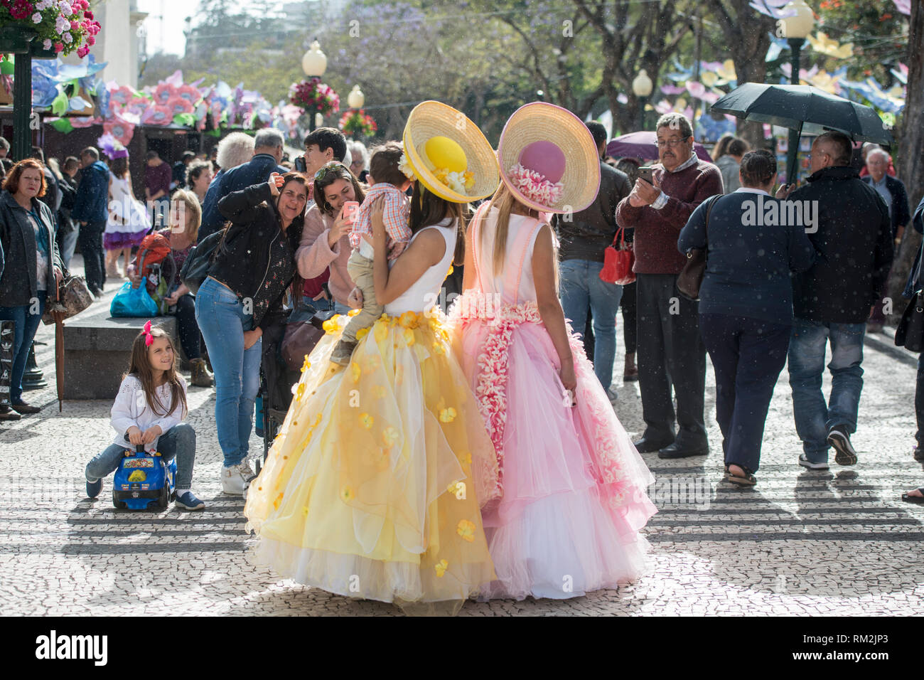 women dressed in colorful clothes at the Festa da Flor or Spring Flower ...