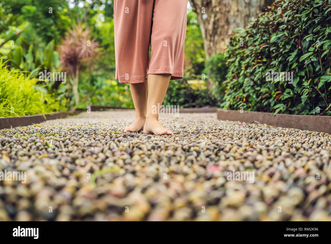 Woman Walking On A Textured Cobble Pavement, Reflexology. Pebble stones ...