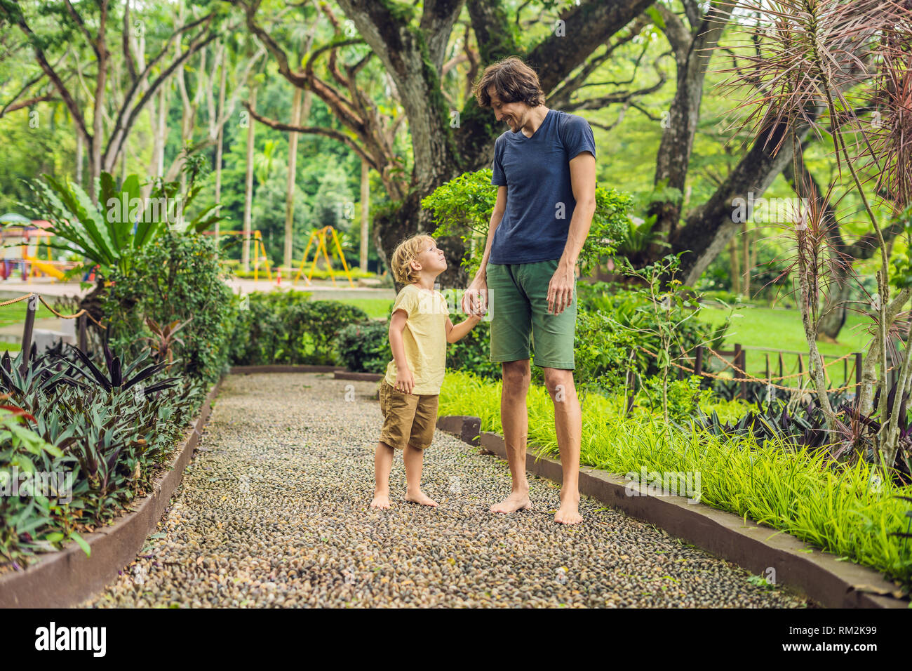 Father and son Walking On A Textured Cobble Pavement, Reflexology ...