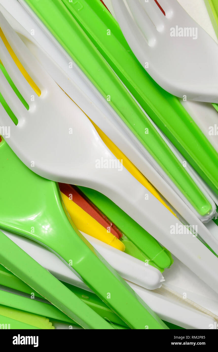 Pile of bright yellow, green and white used plastic kitchenware ...