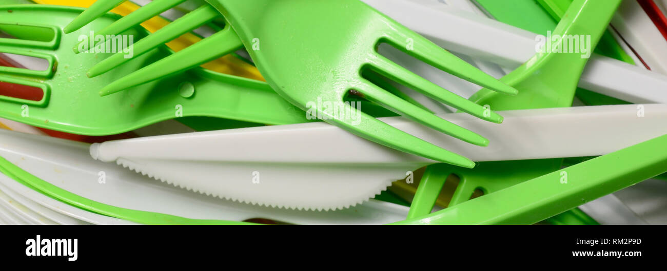 Pile of bright yellow, green and white used plastic kitchenware ...