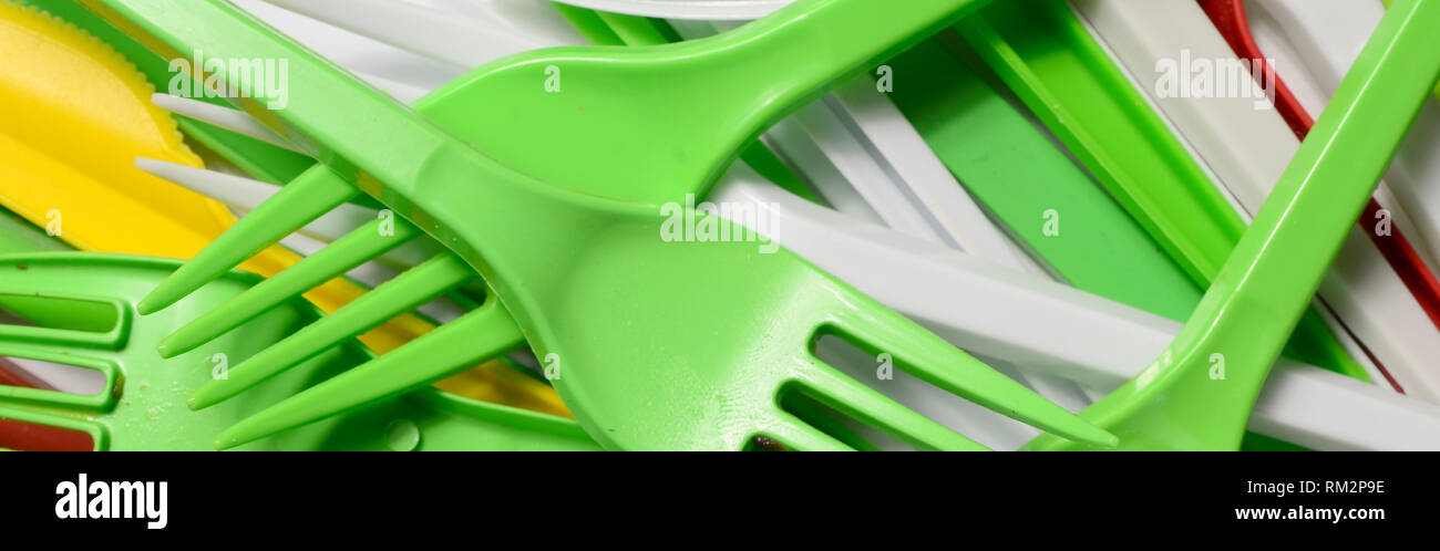 Pile of bright yellow, green and white used plastic kitchenware ...