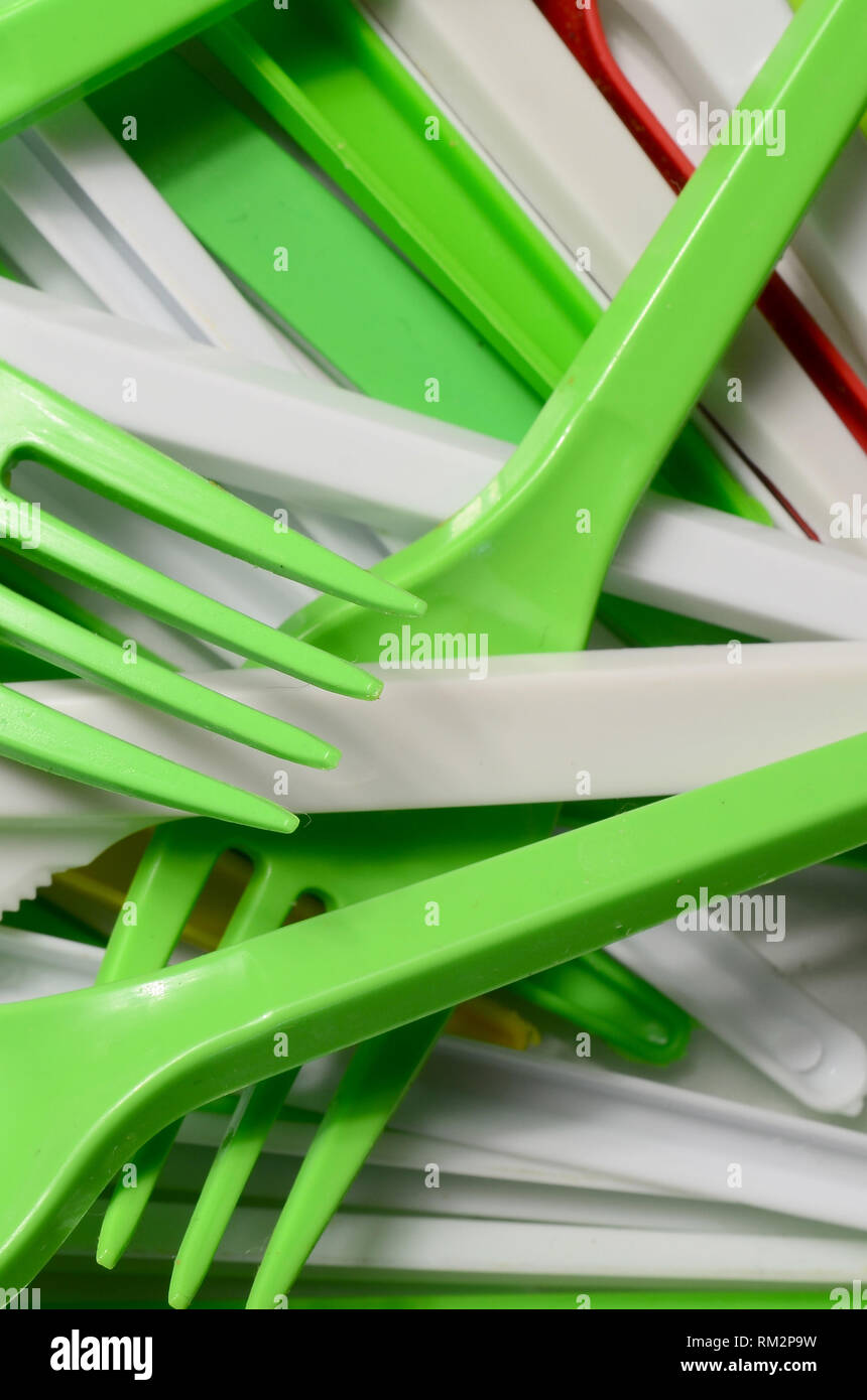 Pile of bright yellow, green and white used plastic kitchenware ...