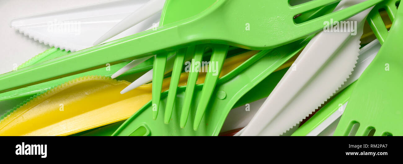 Pile of bright yellow, green and white used plastic kitchenware ...