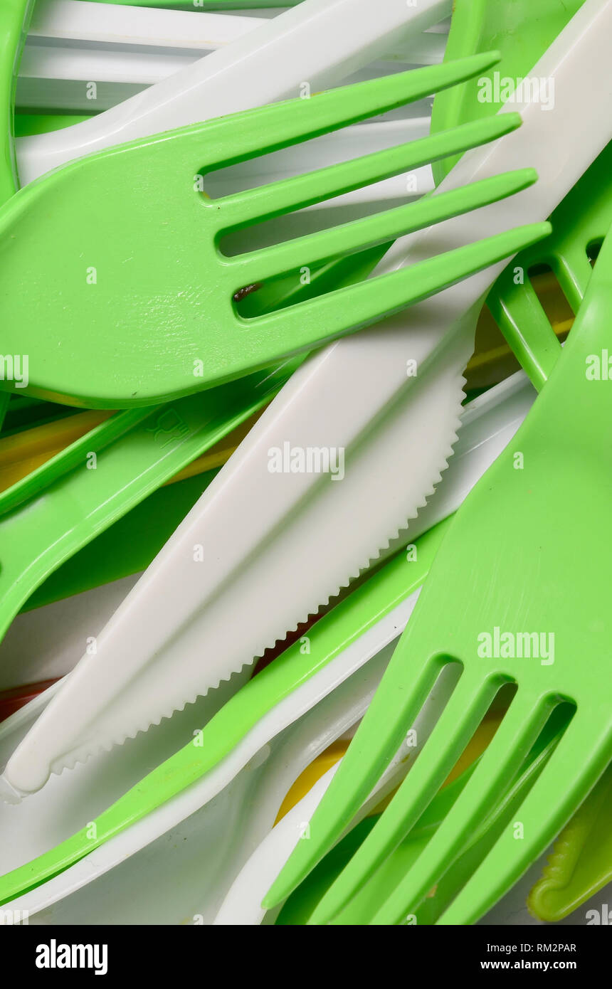 Pile of bright yellow, green and white used plastic kitchenware ...