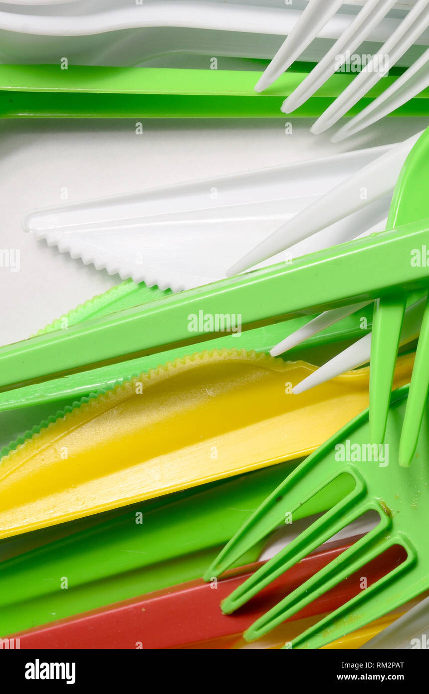 Pile of bright yellow, green and white used plastic kitchenware ...