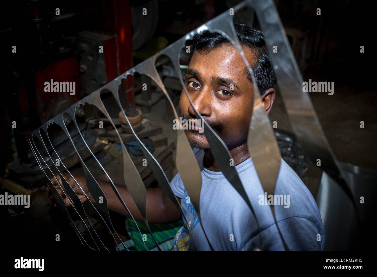 Spoon-Making Factory Workers at a steel recycling and steel spoon ...