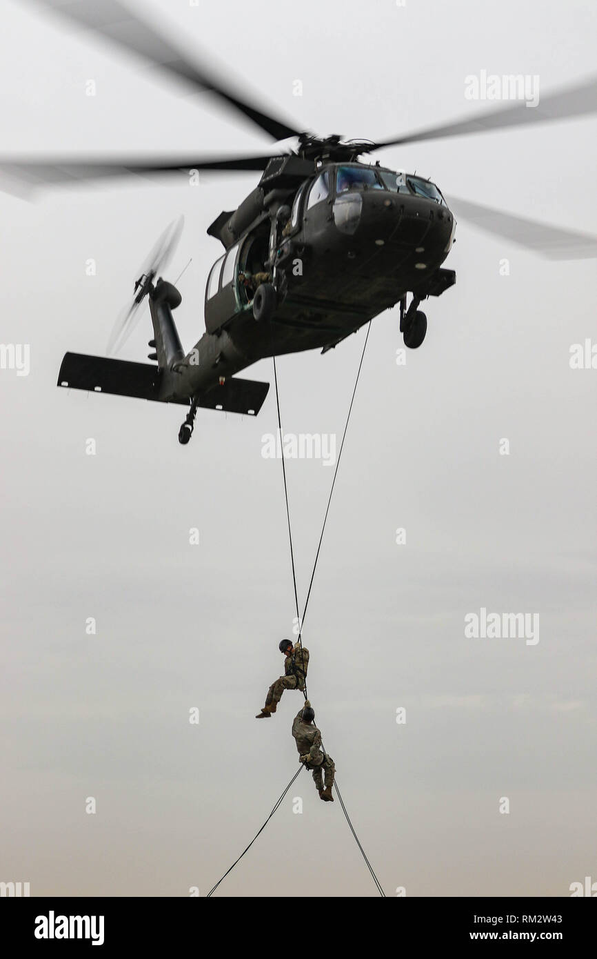 Two U.S. Army Soldiers repel from a UH-60 Black Hawk helicopter during ...
