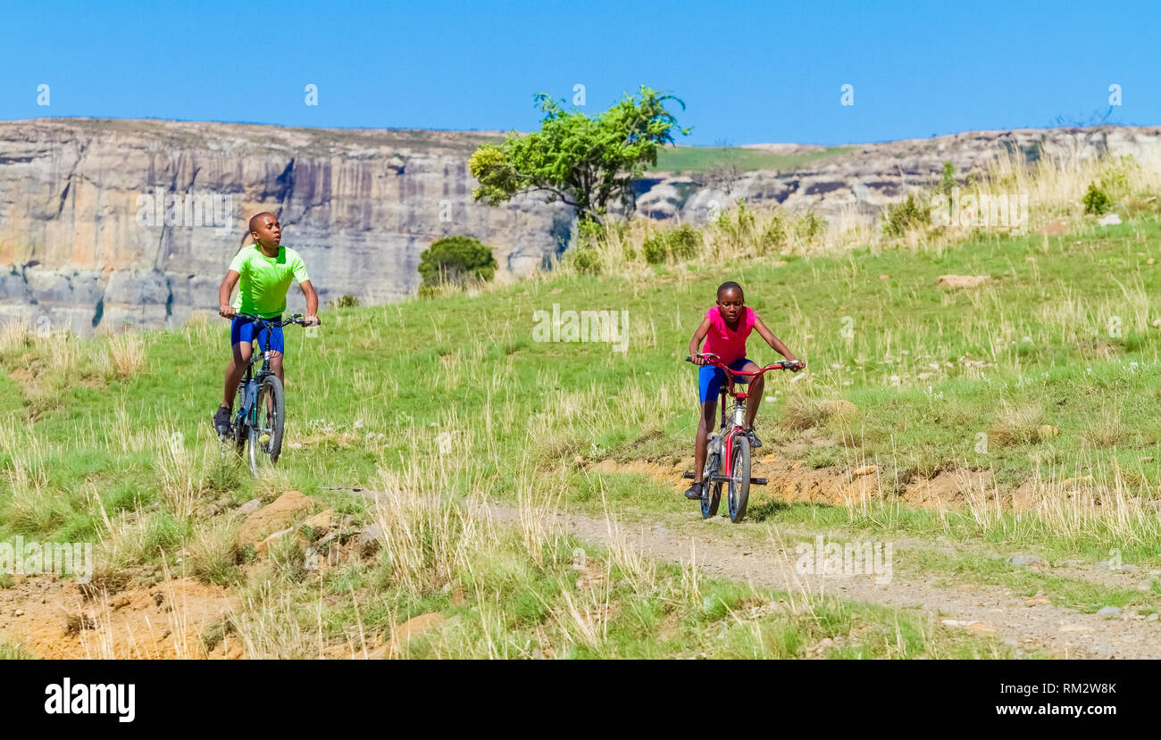 Harrismith, South Africa - October 18 2012: African Children riding a ...
