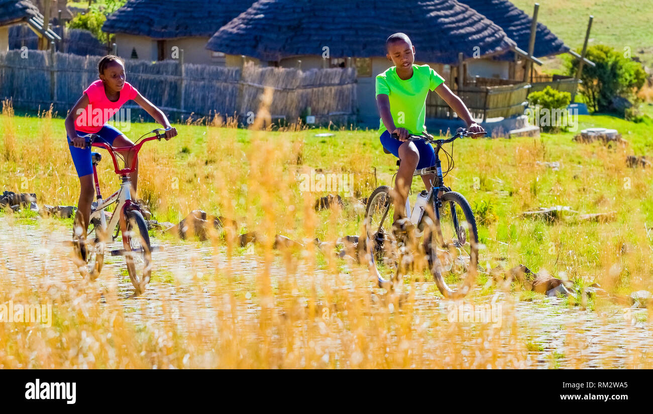 Harrismith, South Africa - October 18 2012: African Children riding a ...