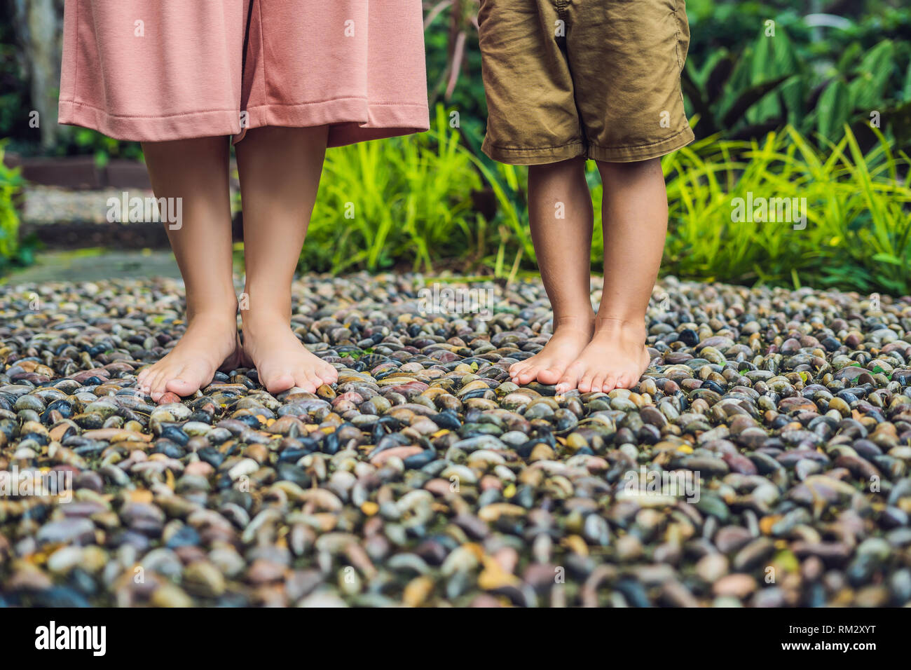Mother and son Walking On A Textured Cobble Pavement, Reflexology ...