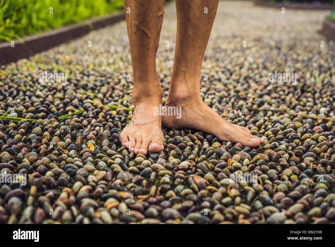 Man Walking On A Textured Cobble Pavement, Reflexology. Pebble stones ...