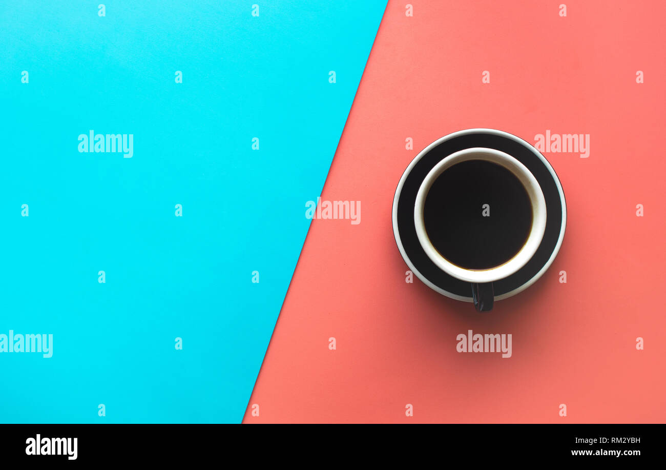 A cup of coffee on colorful pastel background.Top view.Minimal design ...