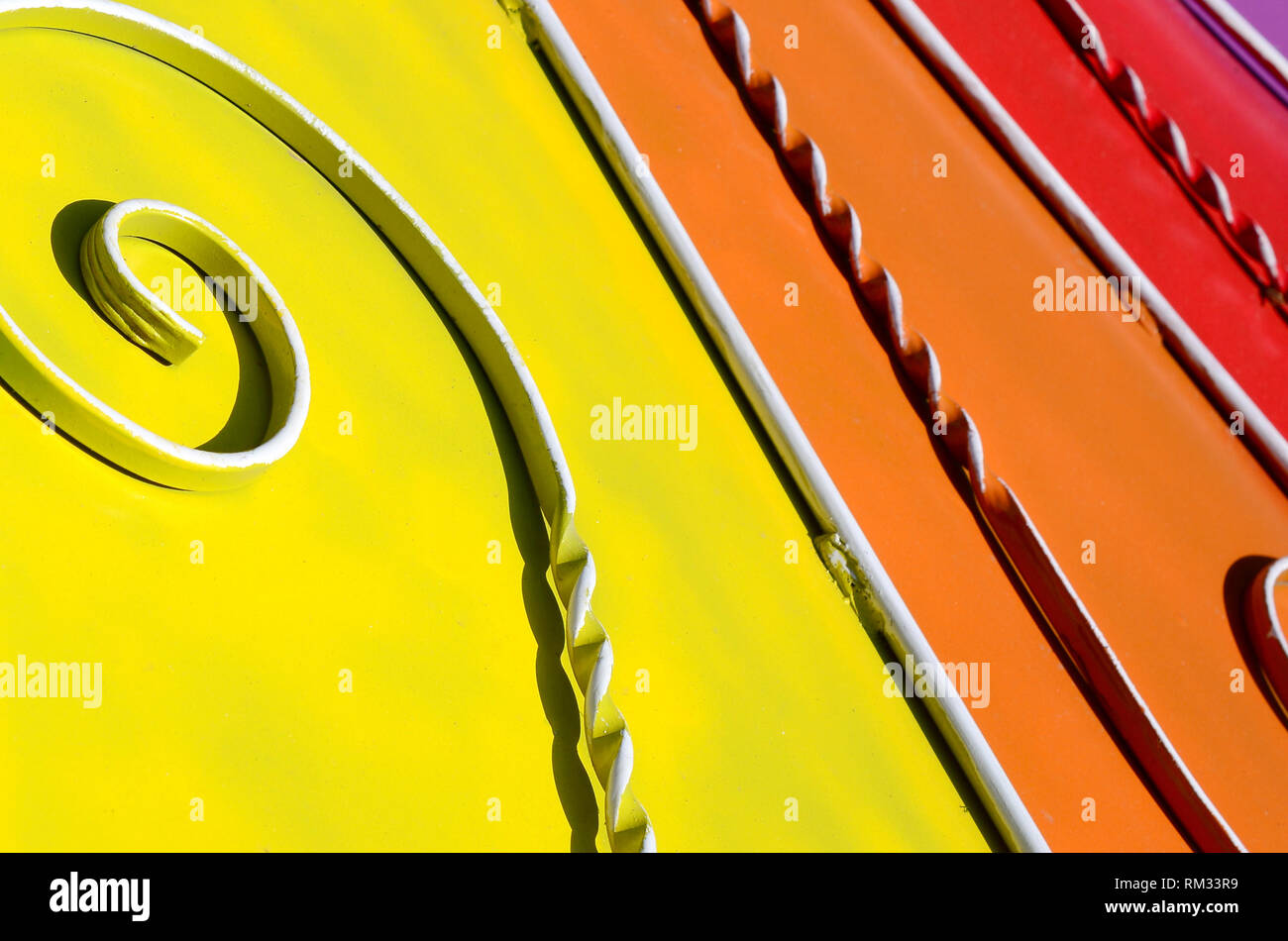 Metal texture of a piece of colored wall with a forged pattern. Rainbow ...