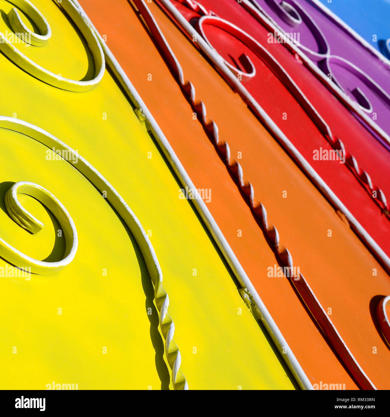 Metal texture of a piece of colored wall with a forged pattern. Rainbow ...
