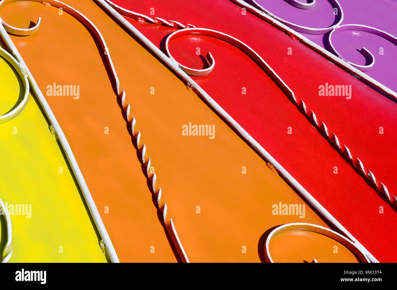 Metal texture of a piece of colored wall with a forged pattern. Rainbow ...