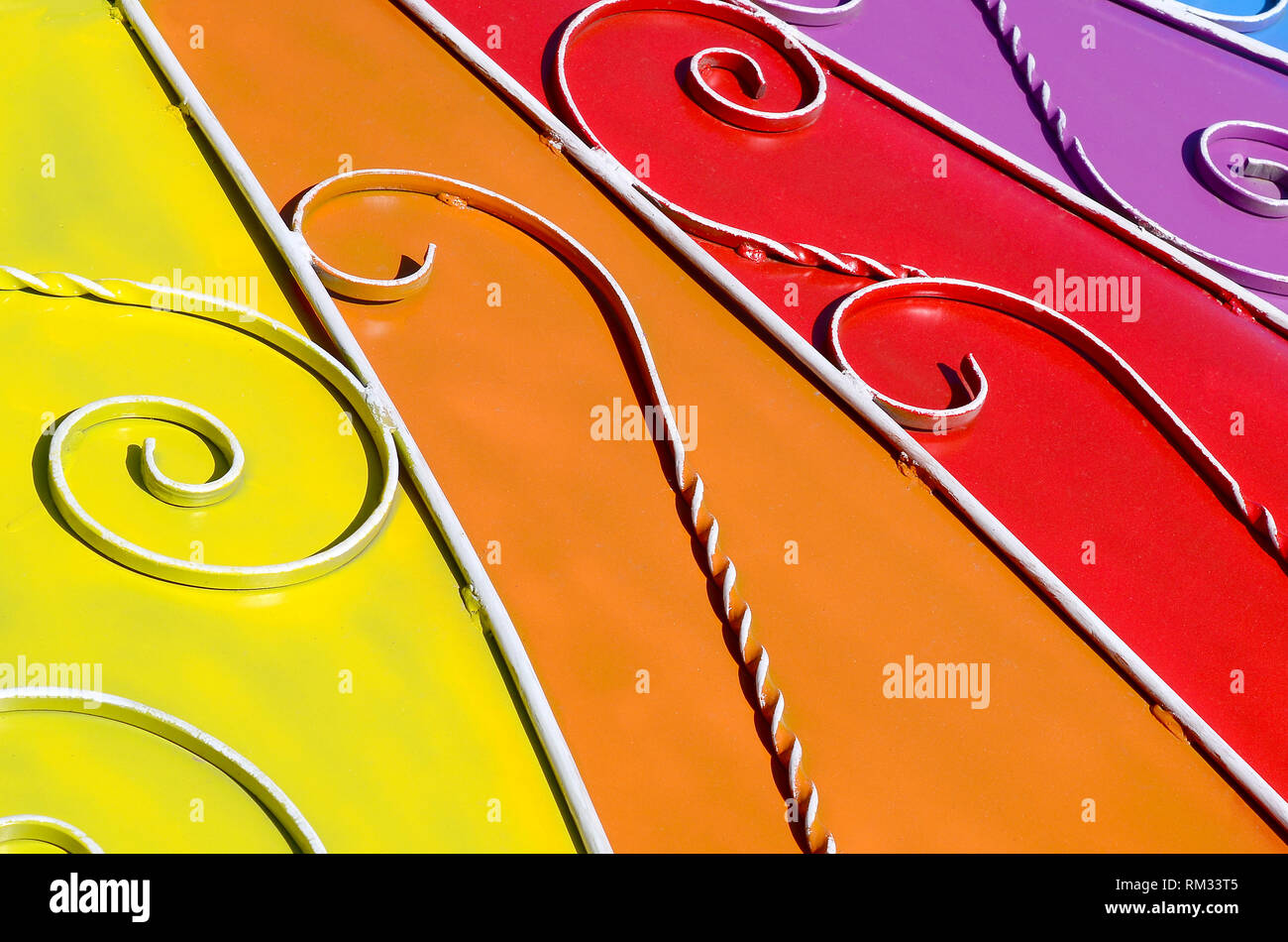 Metal texture of a piece of colored wall with a forged pattern. Rainbow ...