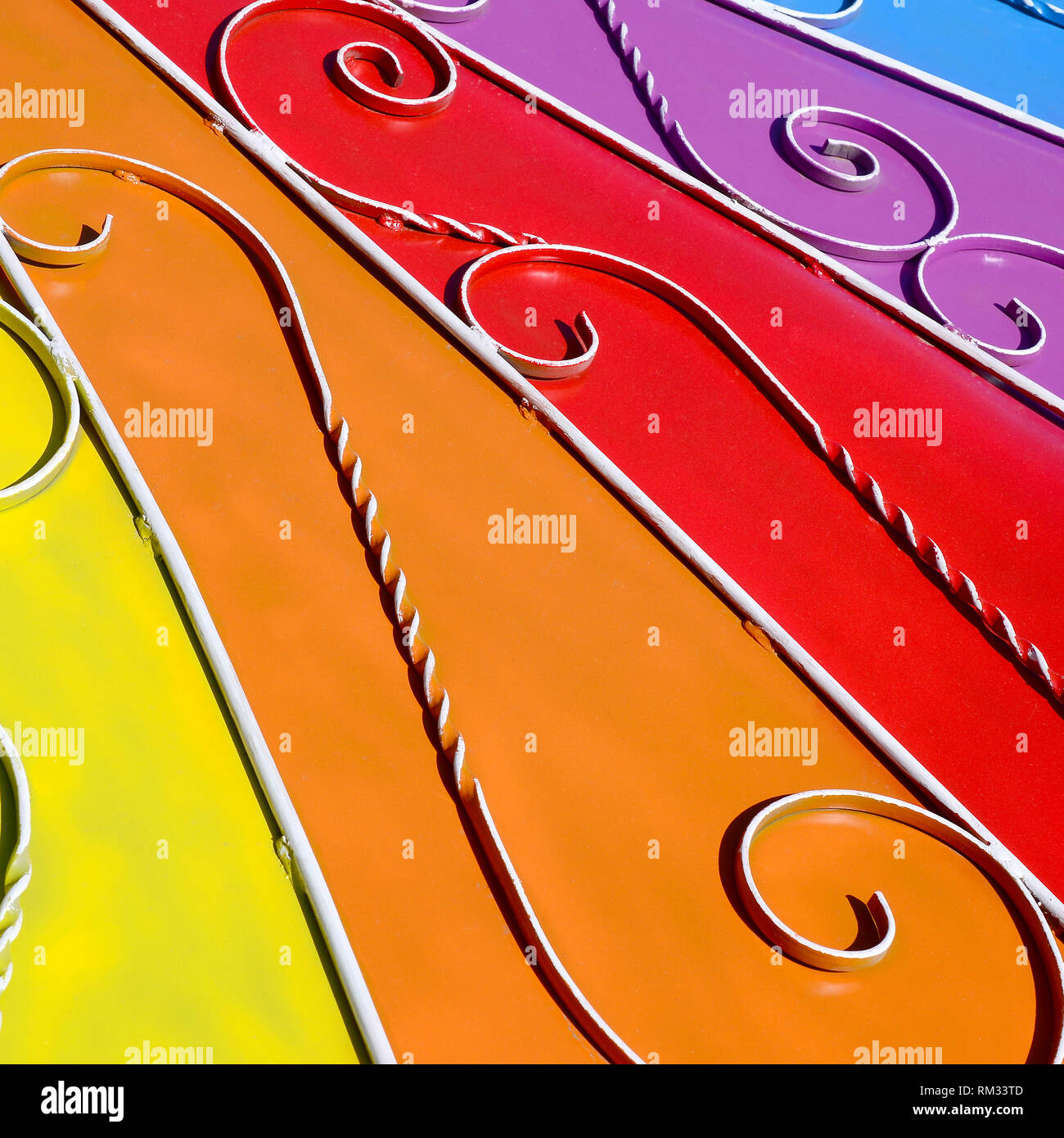 Metal texture of a piece of colored wall with a forged pattern. Rainbow ...