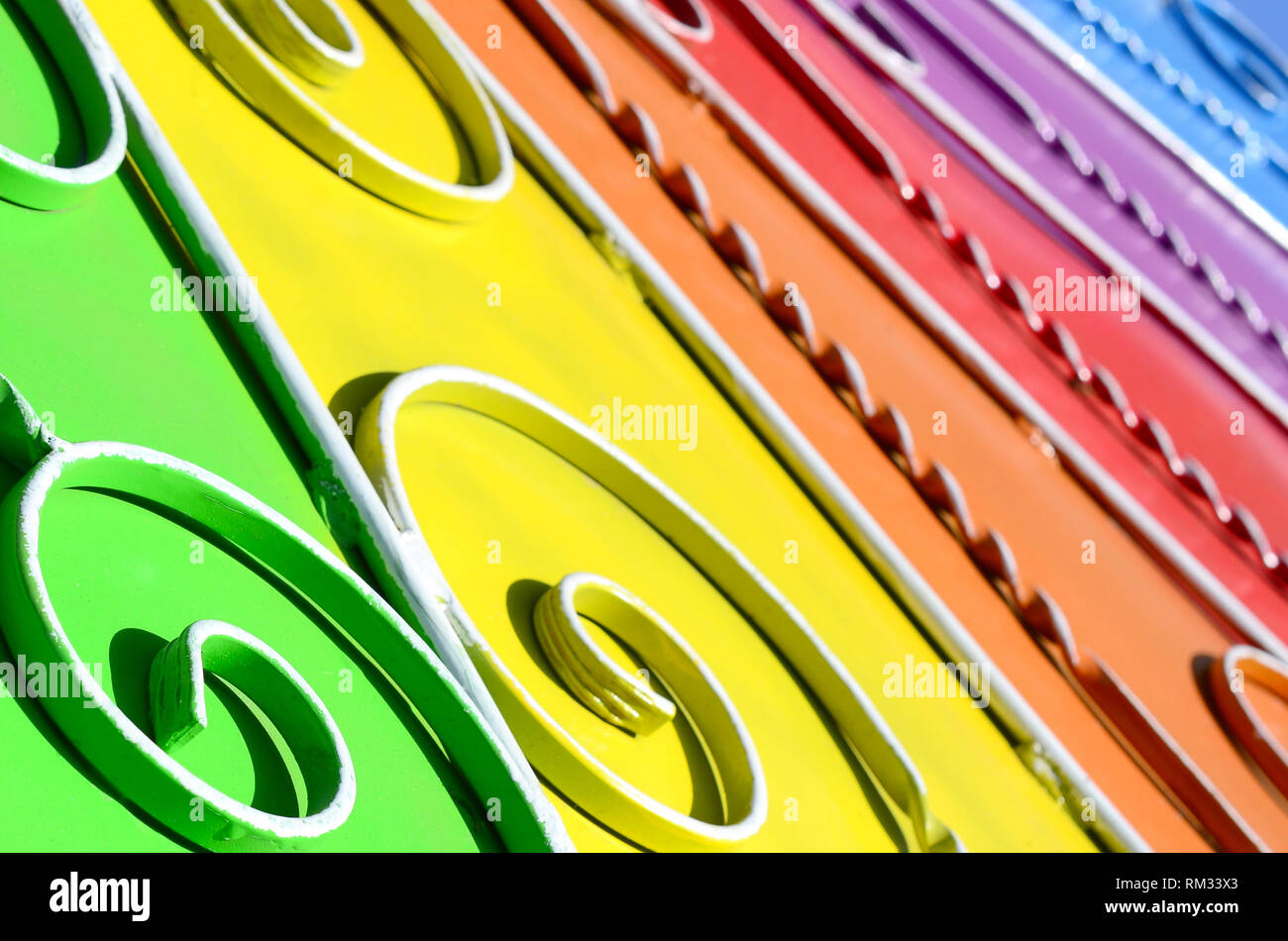 Metal texture of a piece of colored wall with a forged pattern. Rainbow ...