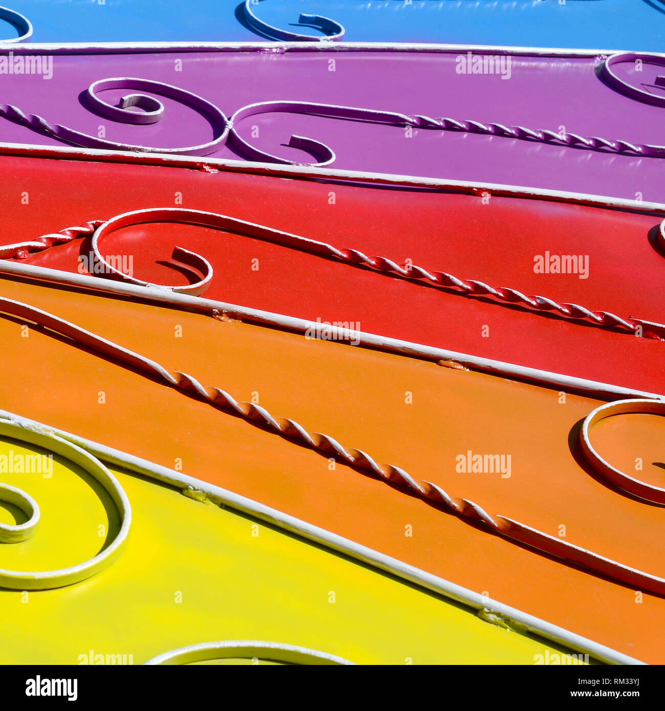 Metal texture of a piece of colored wall with a forged pattern. Rainbow ...