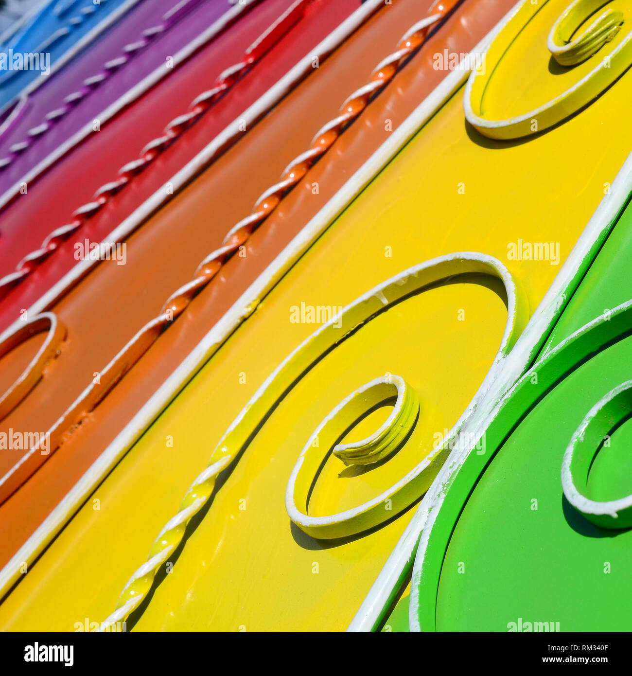 Metal texture of a piece of colored wall with a forged pattern. Rainbow ...
