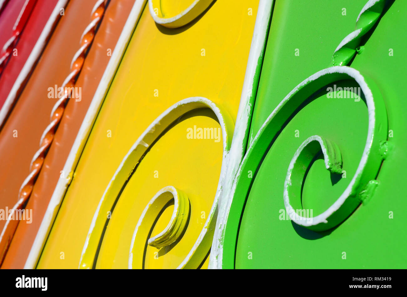Metal texture of a piece of colored wall with a forged pattern. Rainbow ...