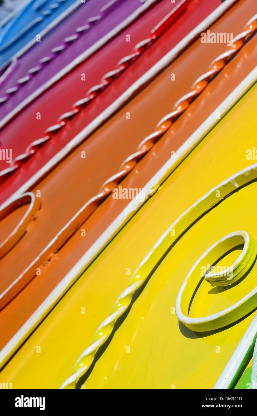 Metal texture of a piece of colored wall with a forged pattern. Rainbow ...
