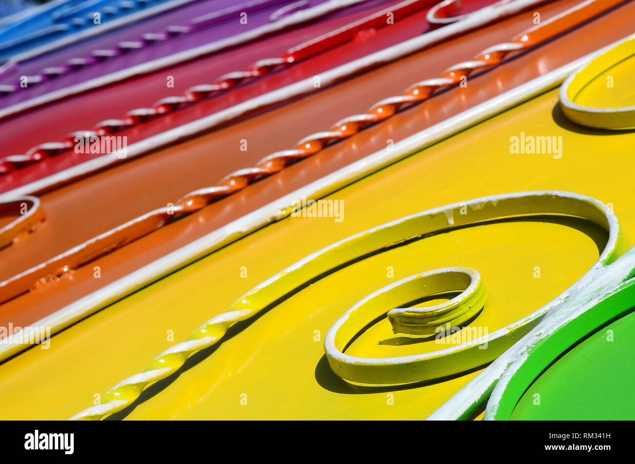 Metal texture of a piece of colored wall with a forged pattern. Rainbow ...