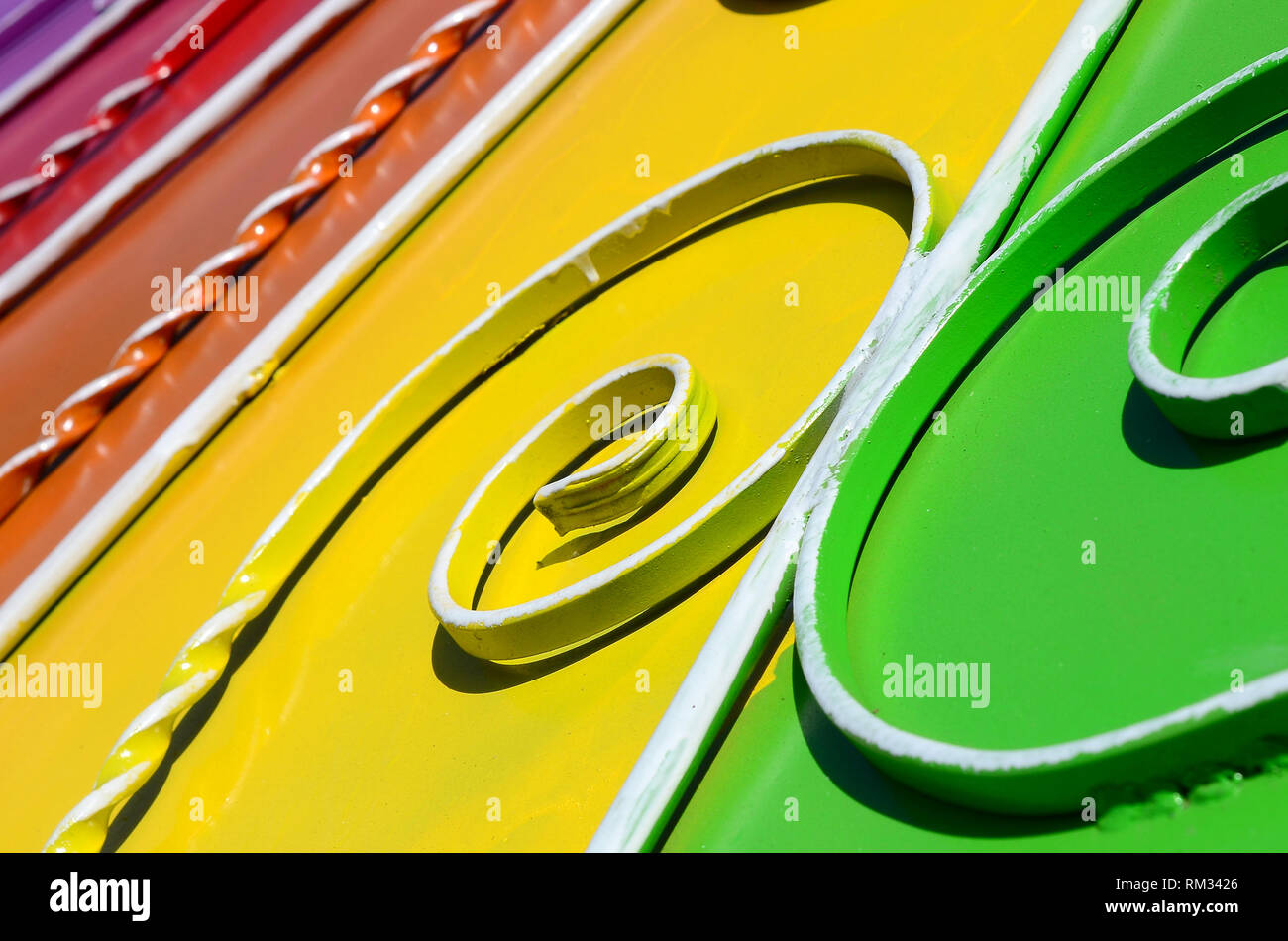 Metal texture of a piece of colored wall with a forged pattern. Rainbow ...