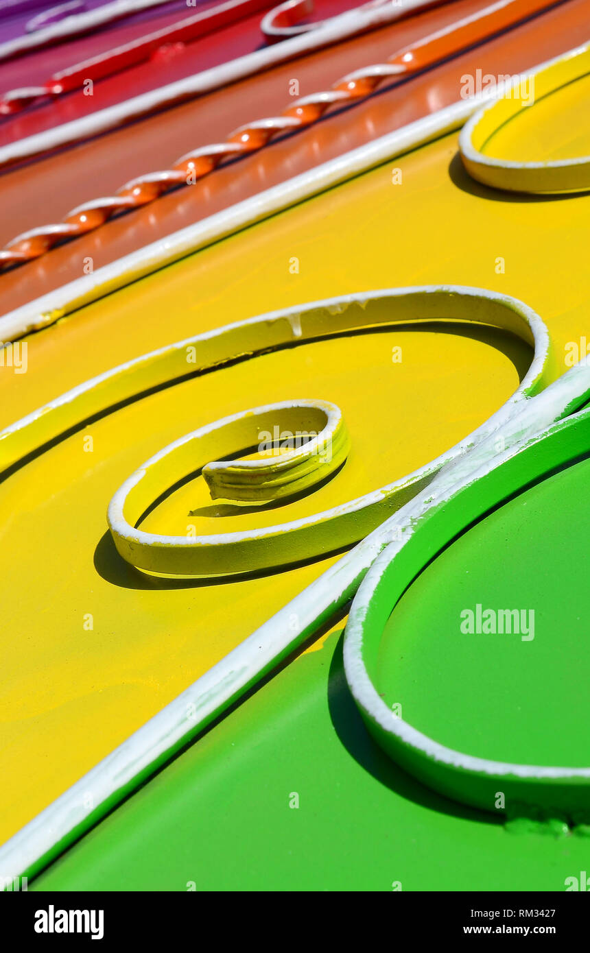 Metal texture of a piece of colored wall with a forged pattern. Rainbow ...