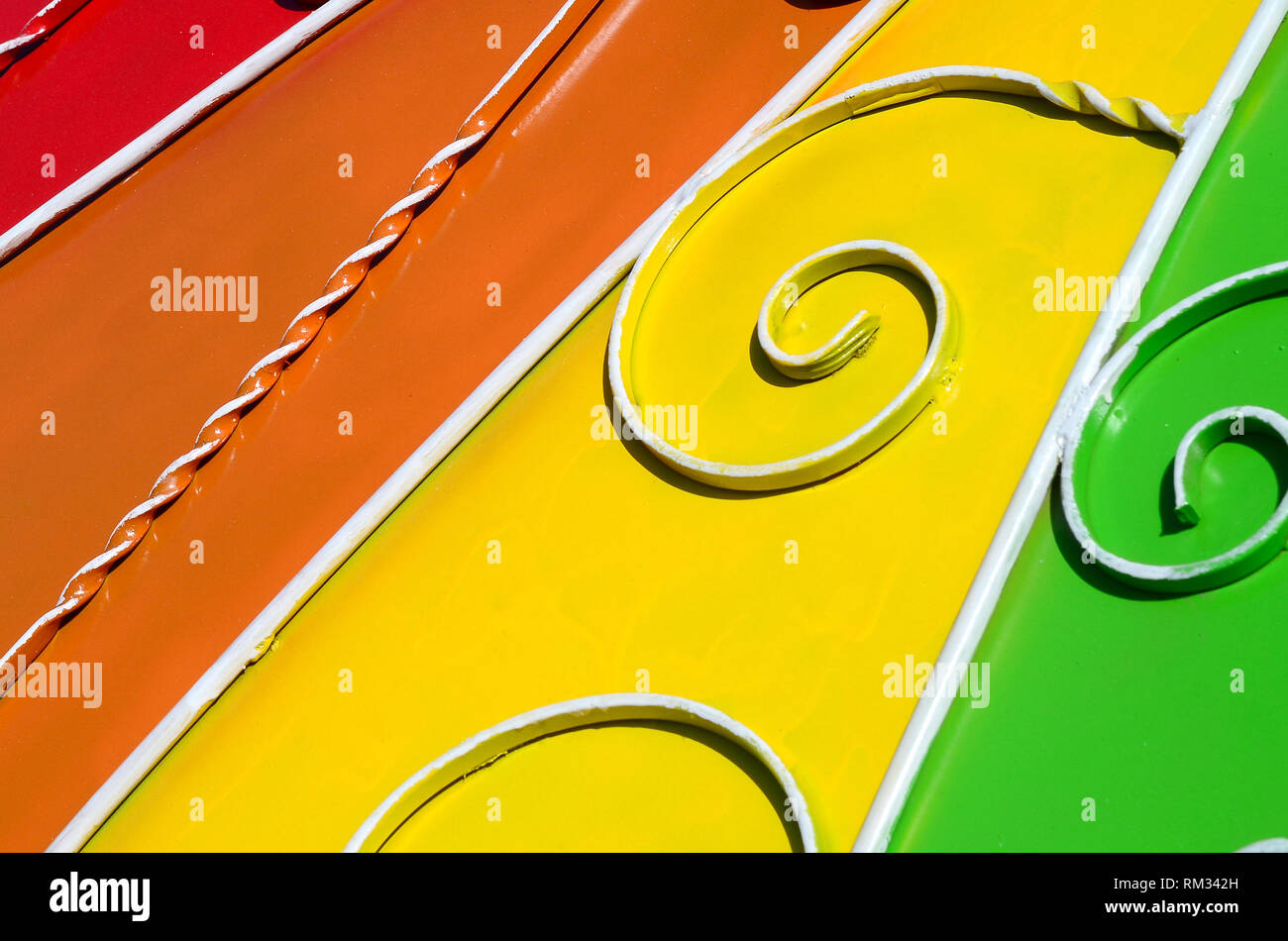 Metal texture of a piece of colored wall with a forged pattern. Rainbow ...