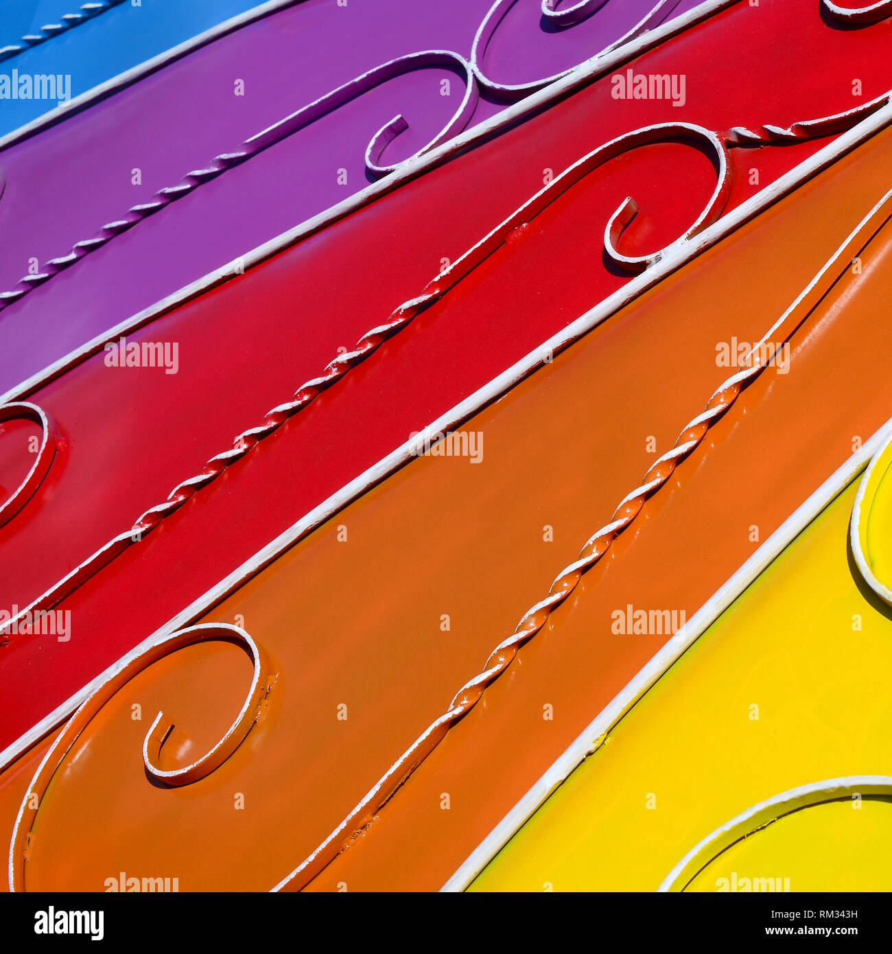 Metal texture of a piece of colored wall with a forged pattern. Rainbow ...