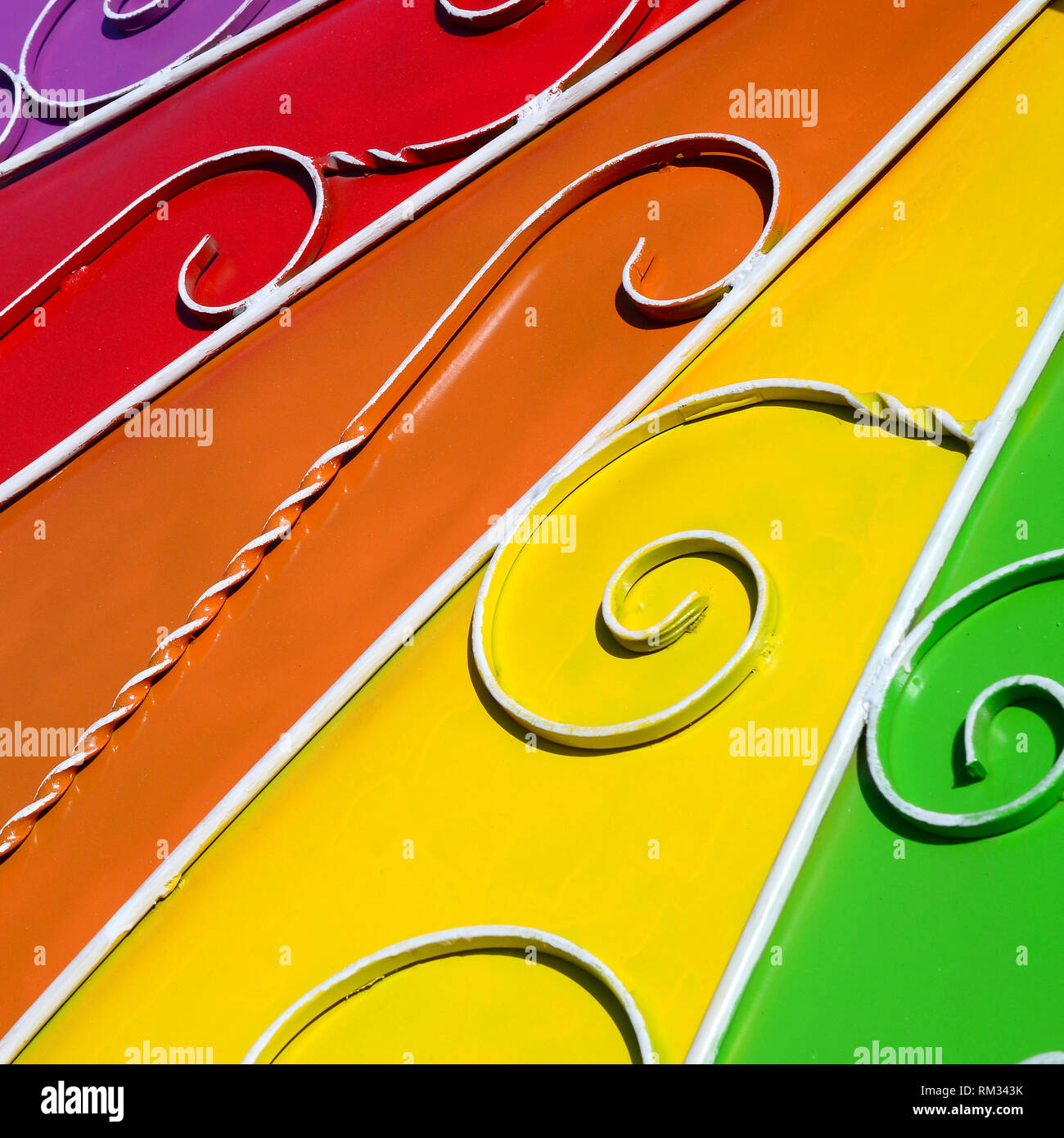 Metal texture of a piece of colored wall with a forged pattern. Rainbow ...