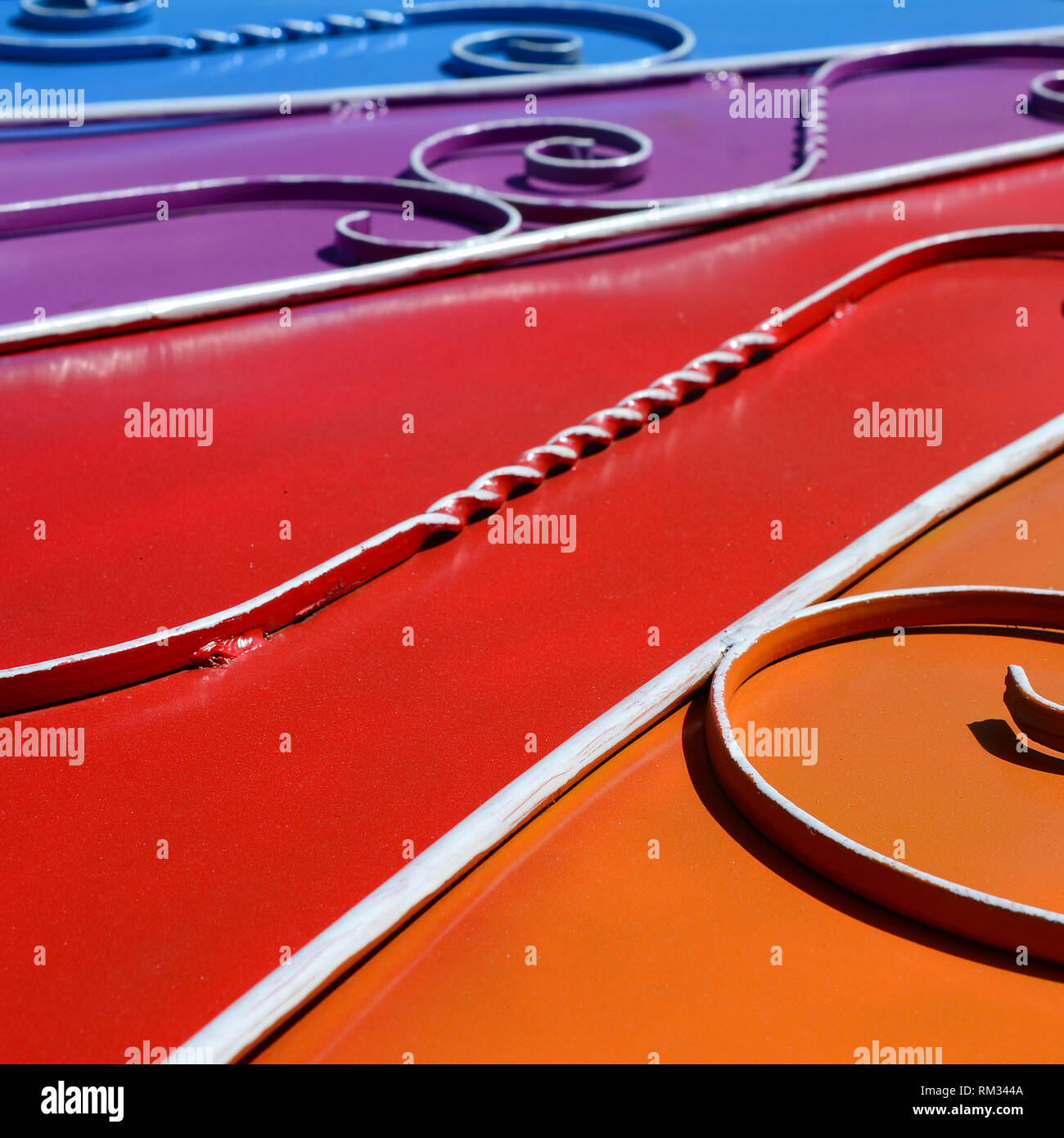 Metal texture of a piece of colored wall with a forged pattern. Rainbow ...