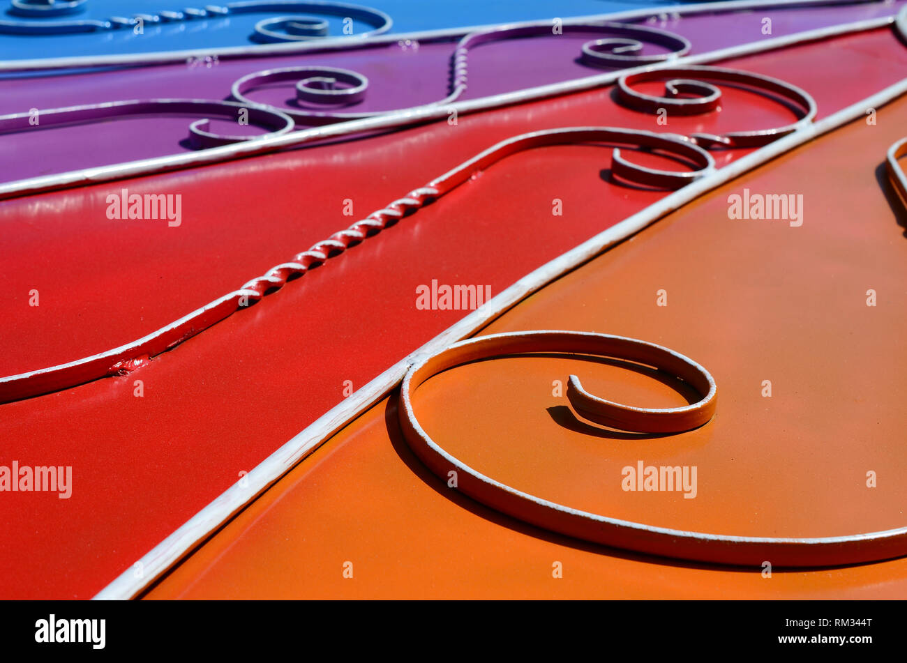 Metal texture of a piece of colored wall with a forged pattern. Rainbow ...