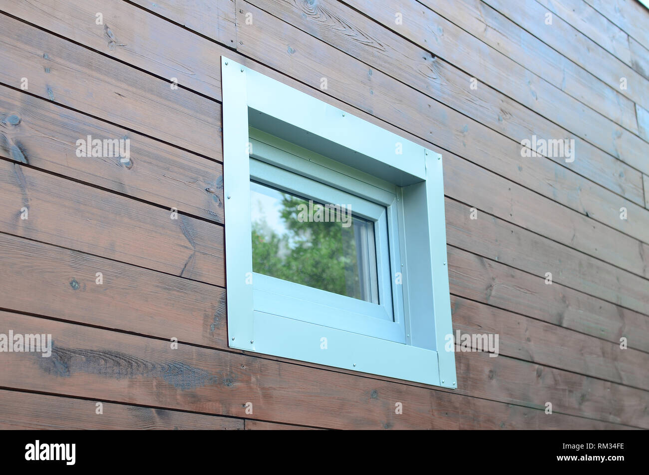 Plastic PVC window in modern passive wooden house facade wall. PVC ...