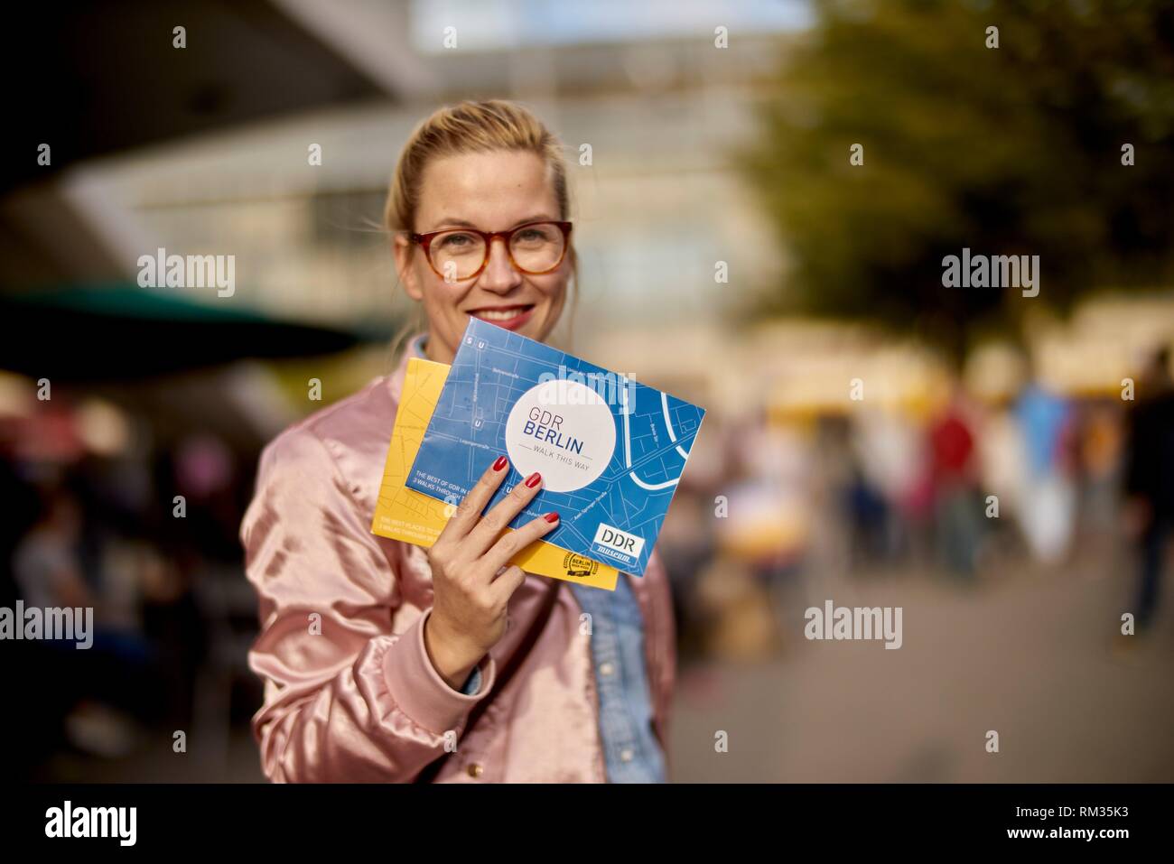 Woman with city tour guide maps in Berlin, Germany Stock Photo - Alamy