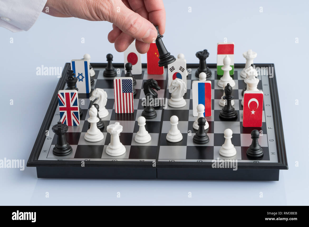 Politician's hand moves a chess piece. Conceptual photo of a political ...