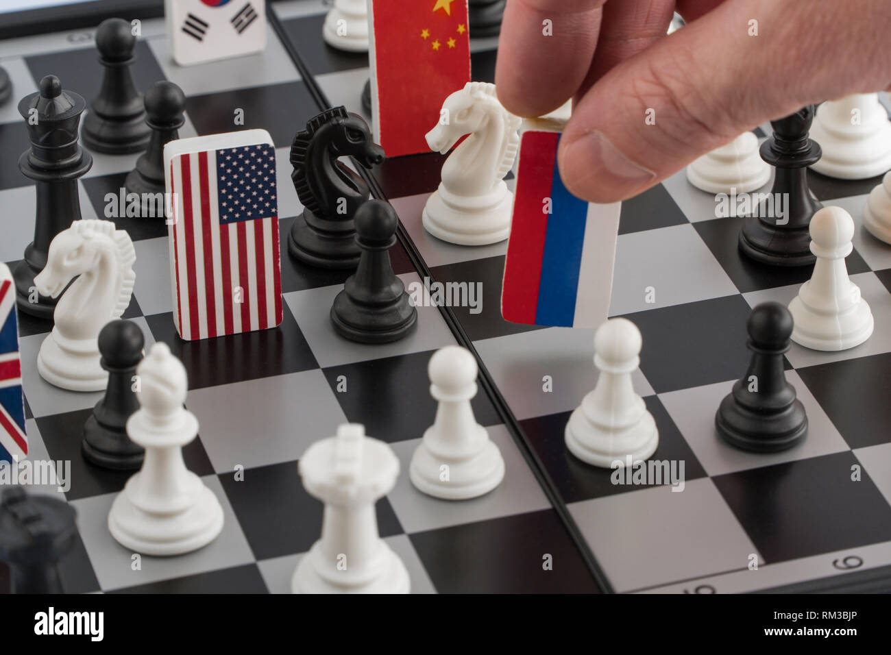 Politician's hand moves a chess piece with a flag. Conceptual photo of ...