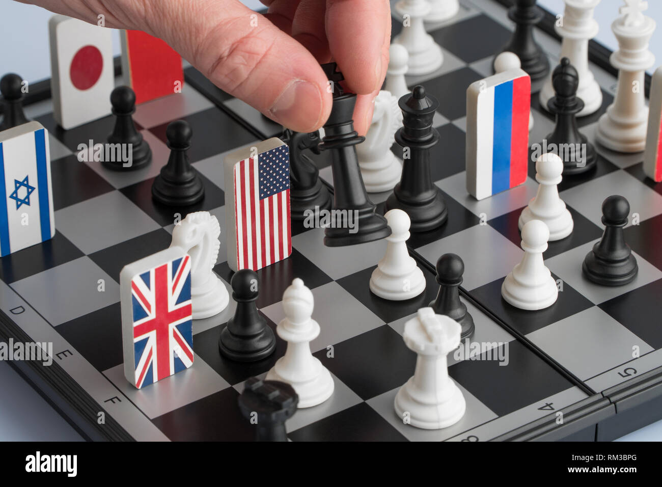 Politician's hand moves a chess piece. Conceptual photo of a political ...