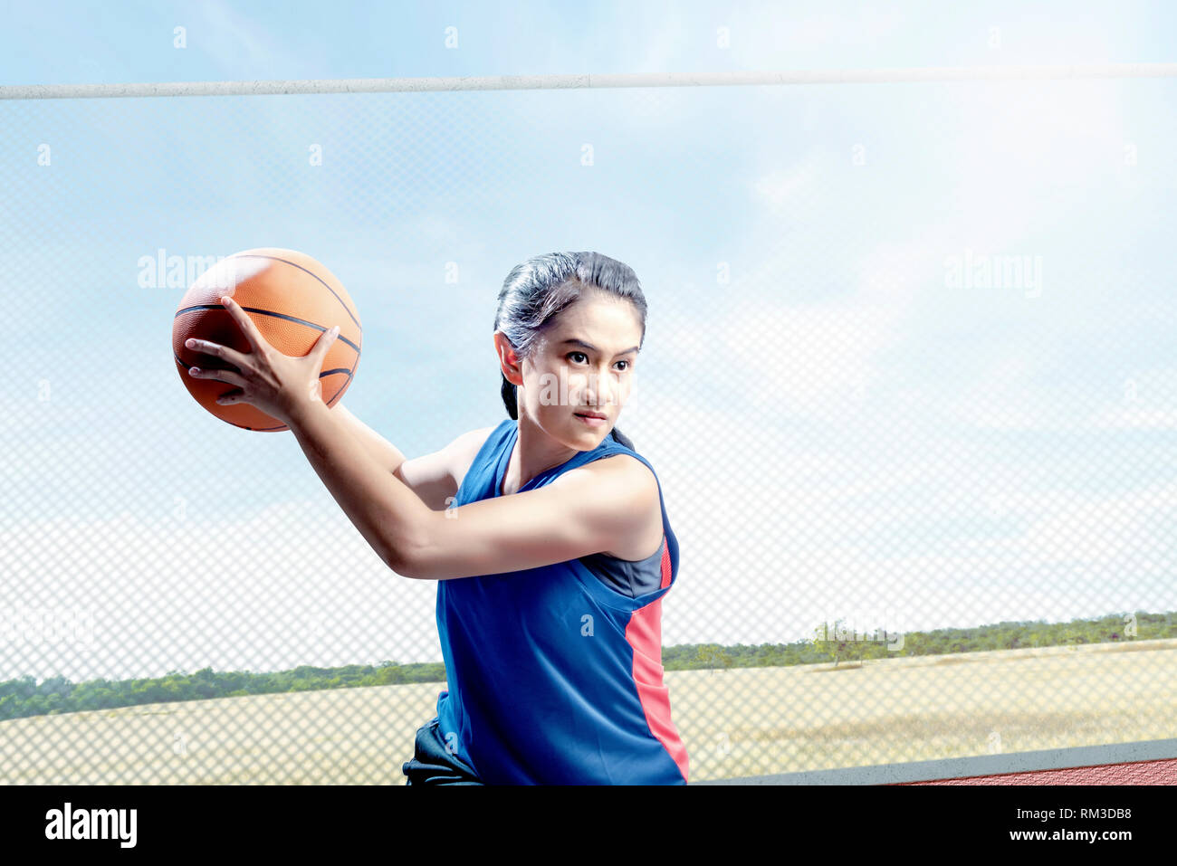 Young asian girl basketball player defending the ball from opponent on ...
