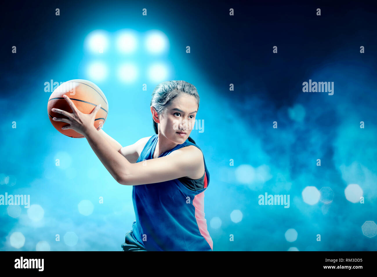 Excited asian girl basketball player defending the ball from opponent ...