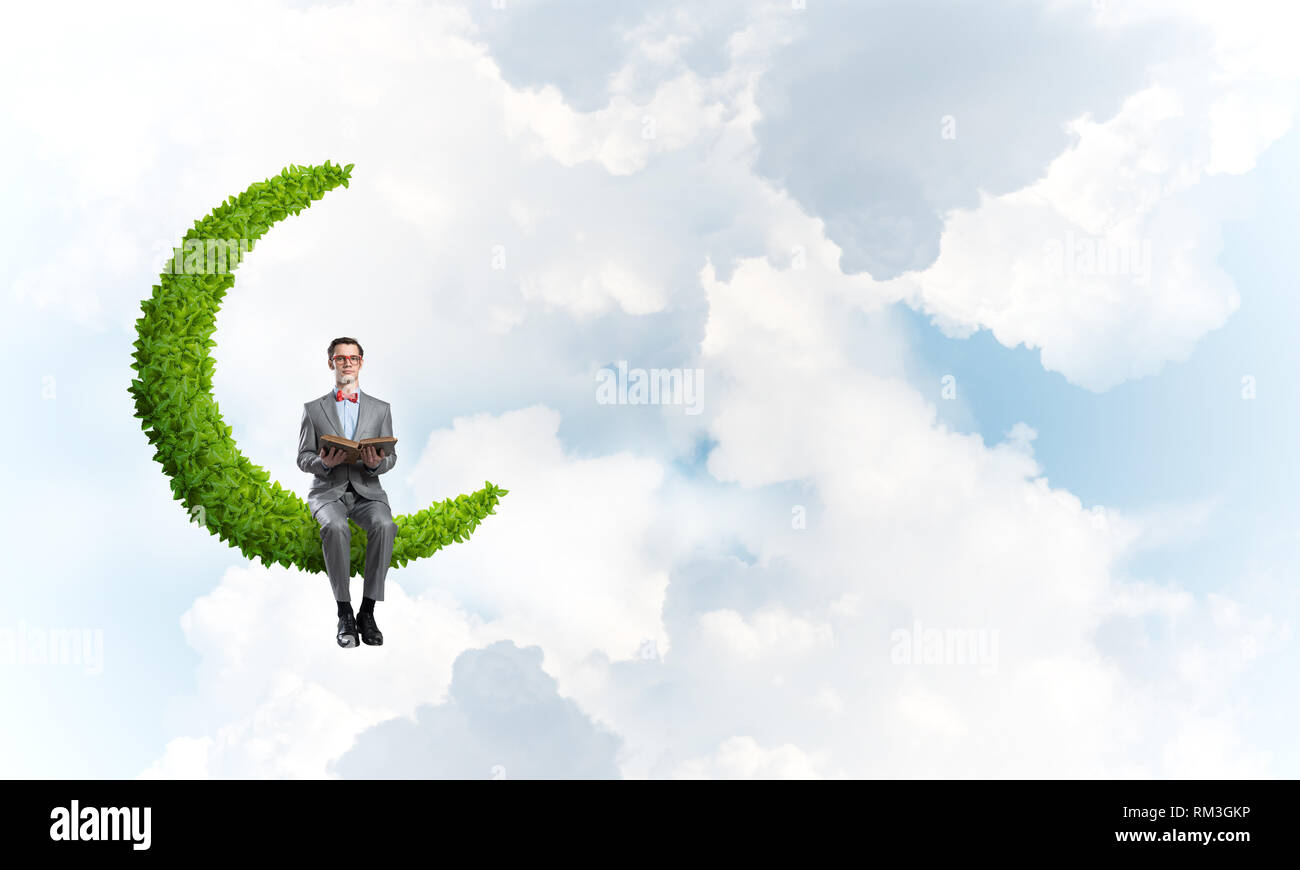 Young businessman or student on moon in sky studying the science Stock ...