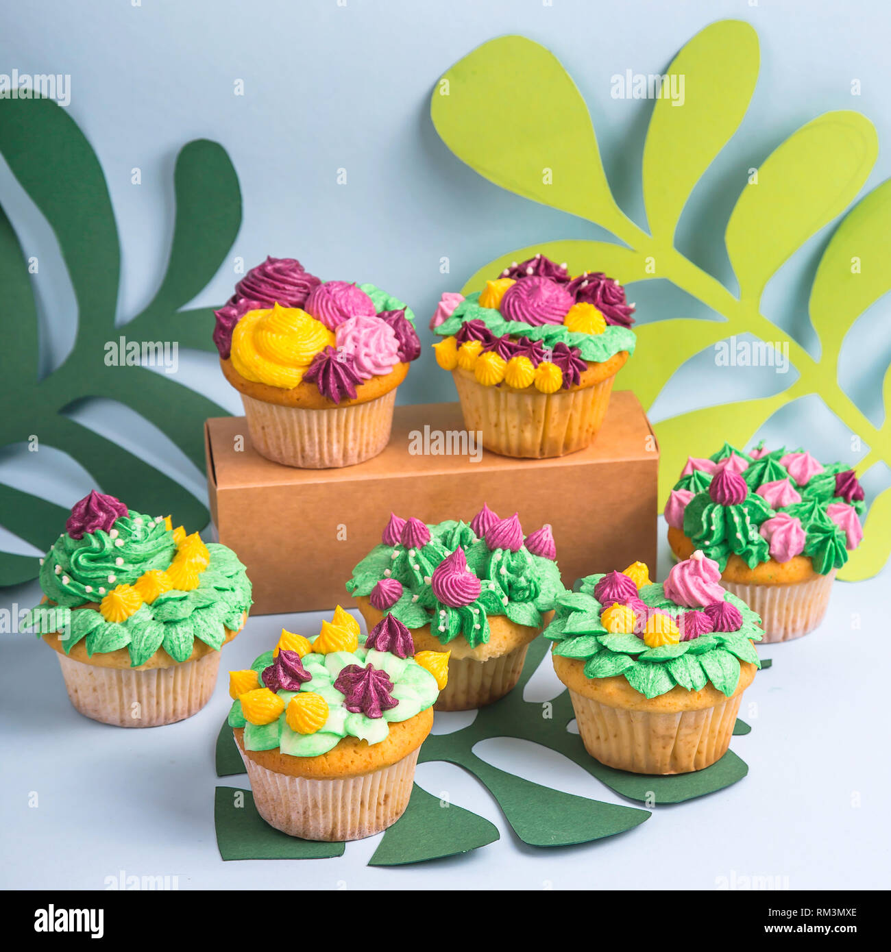 Creative dessert muffin with colorful cream decoration Stock Photo - Alamy
