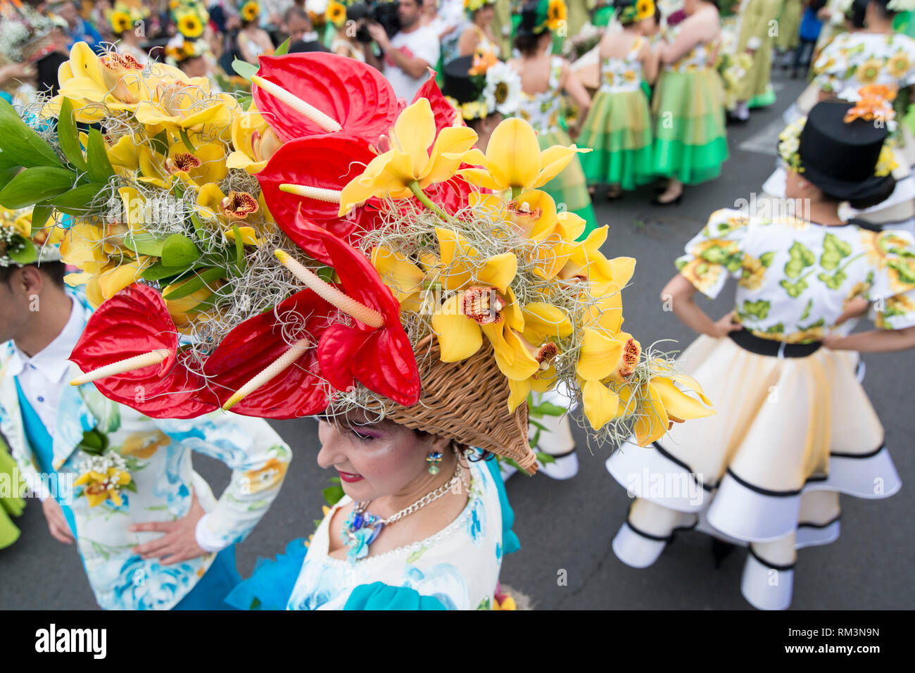 women dressed in colorful clothes at the Festa da Flor or Spring Flower ...