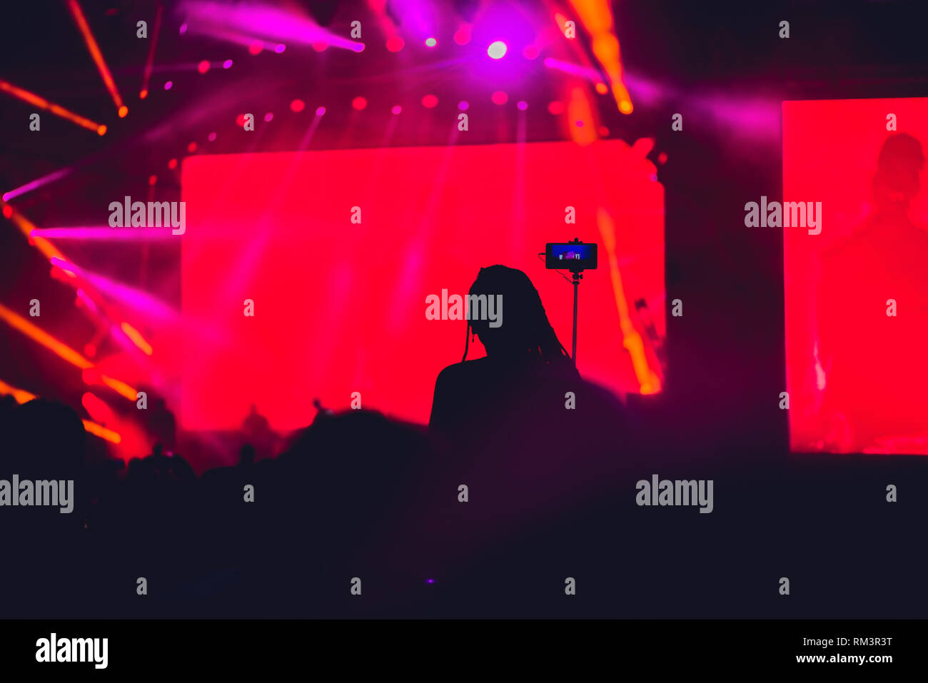 People enjoying rock concert and taking photos with cell phone at music ...